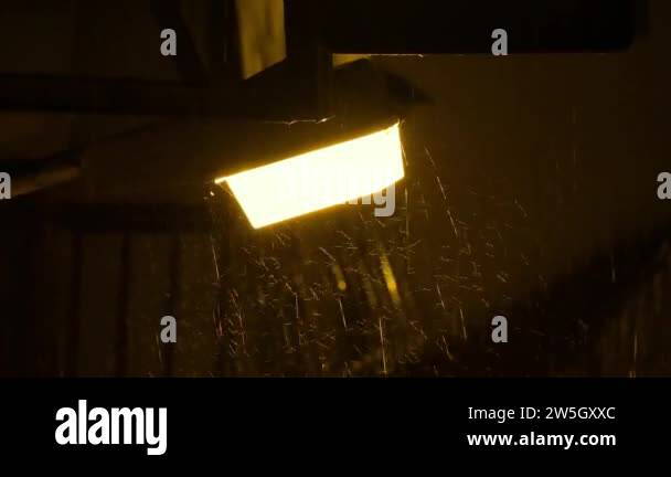 Close up on a street light while pouring heavy rain.4k video at 24 FPS ...