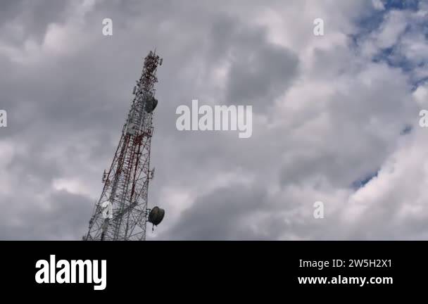 4K time lapse, Gray and white rolling puffy clouds floating in the sky with Telecommunication ...
