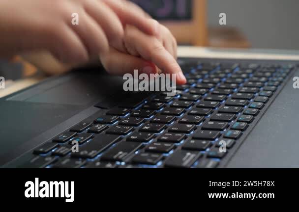 Macro of little child pressing buttons on computer keyboard. Smart new ...