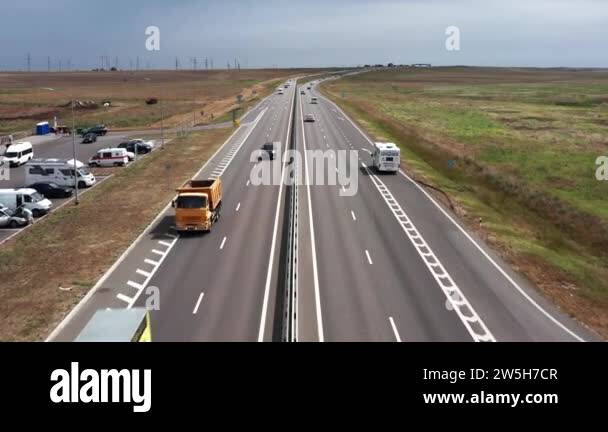 Cars and trucks are traveling on the expressway. Top view. Aerial video ...