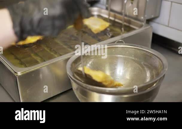 Cooking oil boiling and bubbling in fryer for deep frying dishes in a ...