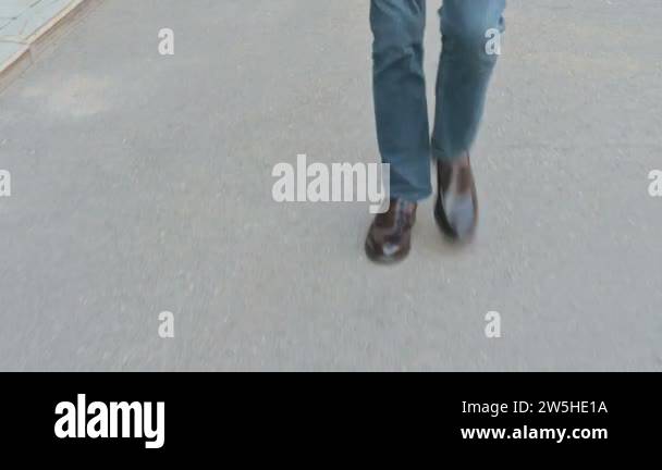 Close up Shot of Feet of African Man Walking on Pavement, Front View ...