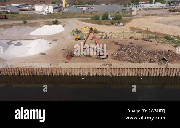 Ecology. Industrial waste. Waste sorting at the landfill using a crane ...