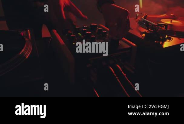 DJ sound control console for mixing dance music in disco club. Hands ...