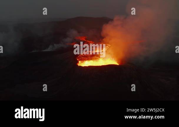 Slide and pan footage of active volcano. Aerial view of boiling magma ...