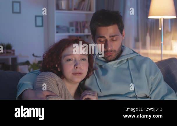 Close-up shot of red-haired Caucasian girl crying watching movie on ...
