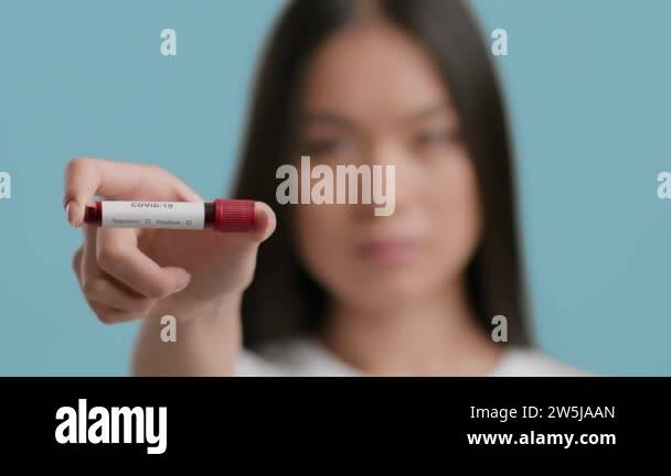 Asian Lady Holding Blood Container For Covid-19 Test, Blue Background ...