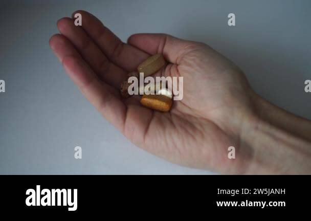 Tablets of various colors and sizes fall into the palm of your hand ...