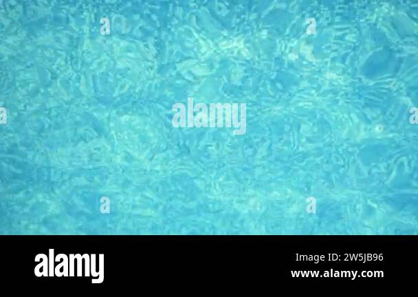 Celeste water moves kaleidocsopically in a fine swimming pool making ...