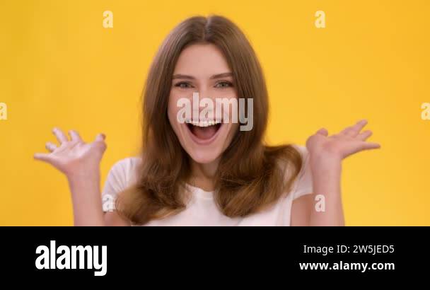 Young happy surprised woman shouting in amazement and delight, touching ...