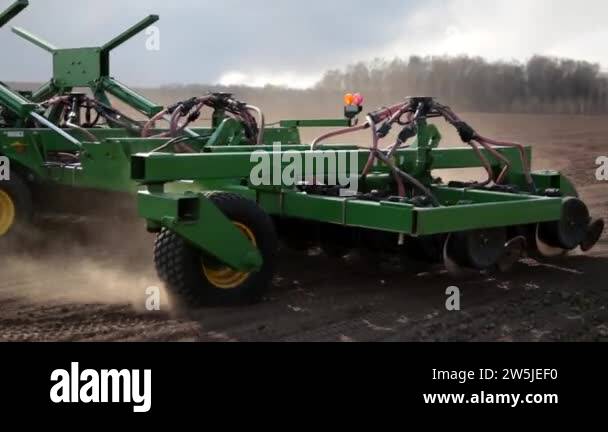 Special agricultural machinery plows and sows the land with grain and ...