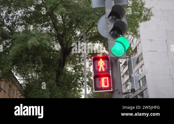 Traffic light in the city. Changes from green to red, urban scene. A ...