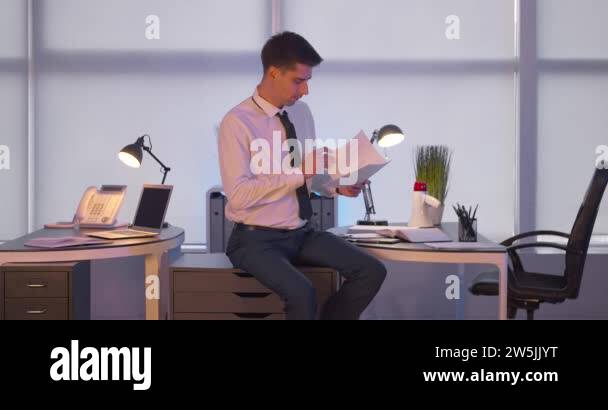 Busy man giving high-five to his lazy colleague who is riding chair and ...