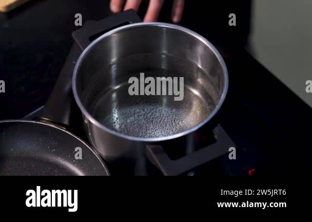 Close up of preparing soup, boiling water in a stainless pot. Art. Top ...