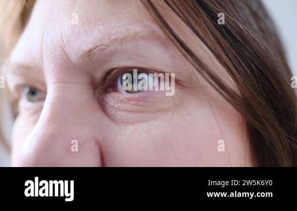 gray eye with spots on iris, wrinkles on eyelids close up, human vision ...