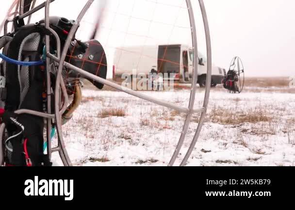 Man starts to work a propeller, motor, engine of the paramotor ...