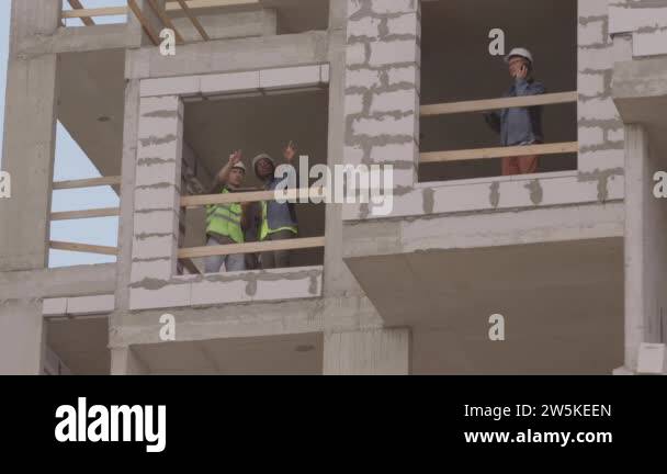 Low angle wide of three diverse construction workers wearing work ...