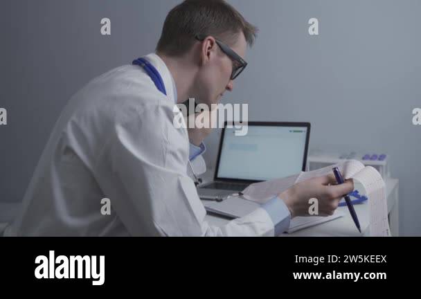Electrocardiogram, ECG in hand doctor cardiologist. Clinic of ...