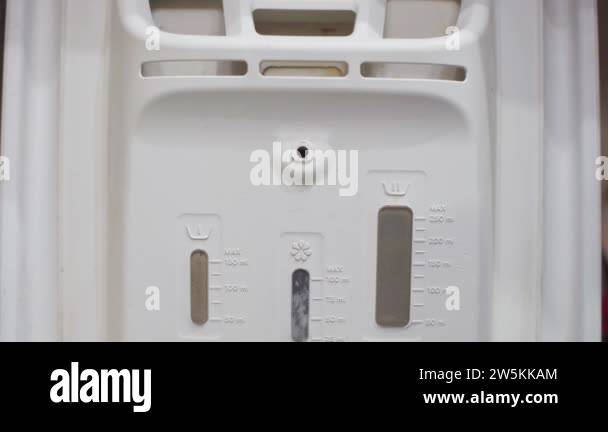 The automatic washing machine is filled with a liquid that softens the ...