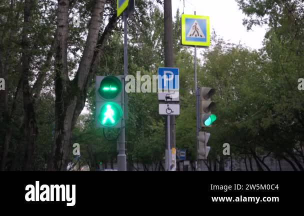 Traffic light in the city. Changes from green to red, urban scene. A ...