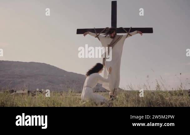 Mary mourns the death of Jesus at his feet. Jesus is crucified on the cross Stock Video Footage ...