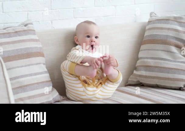 First steps of child. Cute little baby is happy that he climbed onto ...