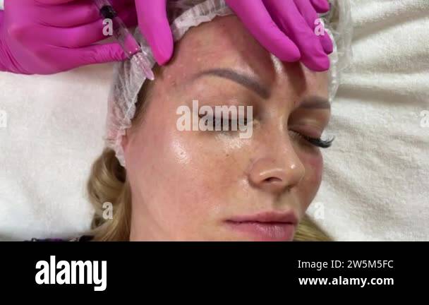 Anti-aging procedure: professional cosmetologist makes multiple ...