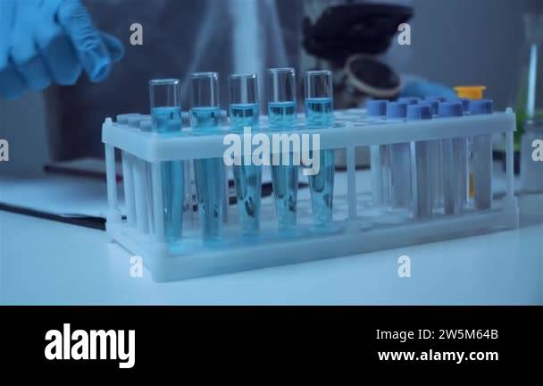 Biochemistry laboratory research, chemist in protective suit analyzing ...