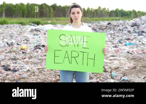 portrait young woman activist with a poster in hands save earth stands ...