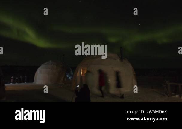 Tourists on the platform about igloo are filming the northern lights in ...