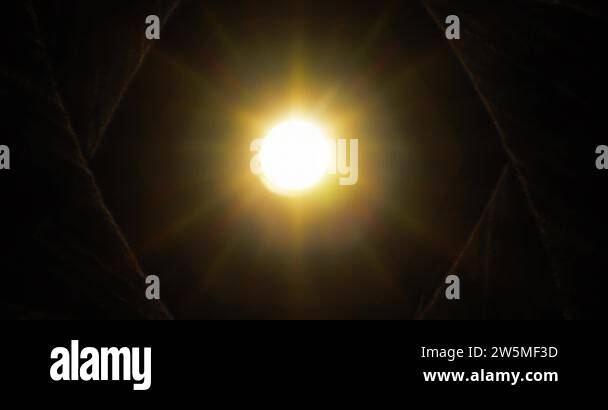 Light rays shining through old camera lens, while diaphragm blades are ...