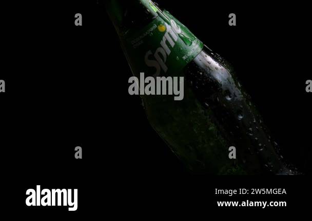 Sprite bottle in drops. A drop flows down the bottle. Cold drinks Stock ...