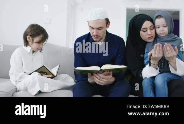 Traditional muslim family parents with children reading Quran and ...