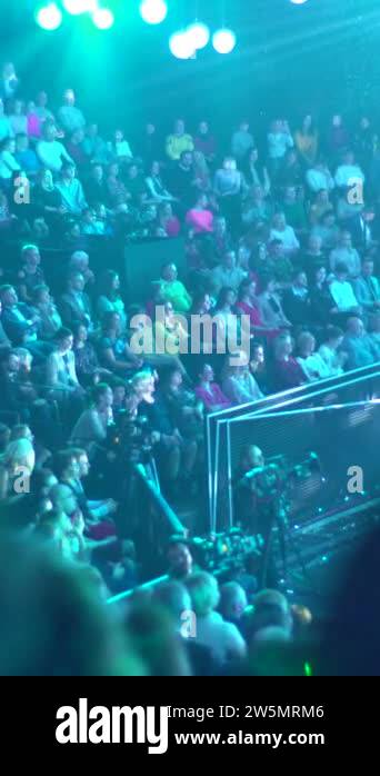People viewers in a TV studio while recording a TV show. Vertical video ...