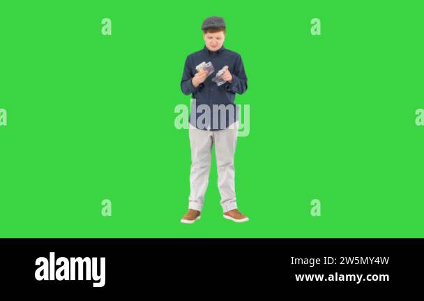 Rich teenager Happy boy counting euros on a Green Screen, Chroma Key ...