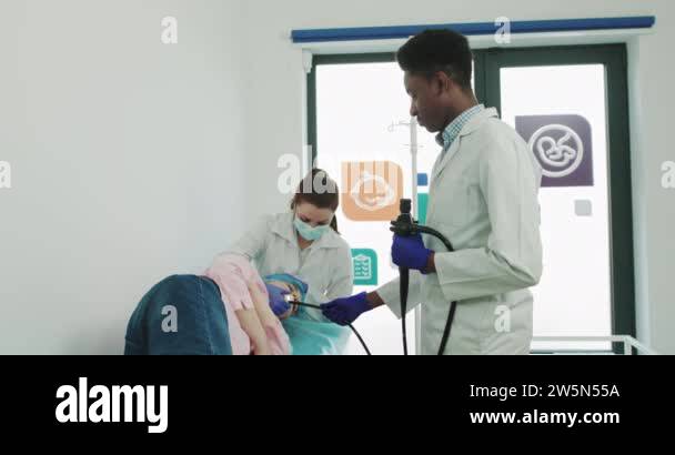 Medical Team Examining Colon Of Patient Who Lying On Bed ...