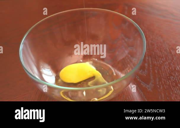 The cook breaks the egg into a glass, transparent plate. The chef ...