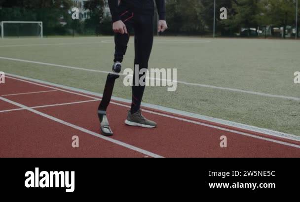 Crop view of disabled male person with prosthetic running blades ...