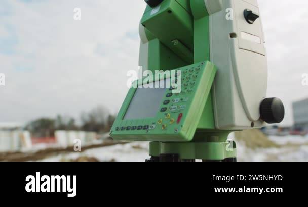 Professional Engineer Surveyor Takes Measures with Theodolite. Worker Using Theodolite Surveying ...