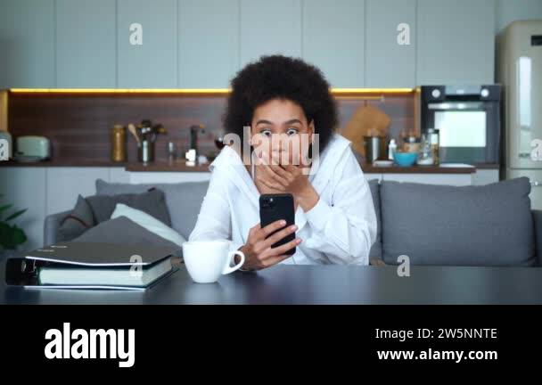 Beautiful young mixed race African American woman with mobile phone ...