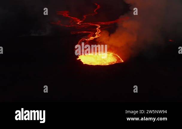 Forwards fly above crater of active volcano. Erupting hot magma and ...