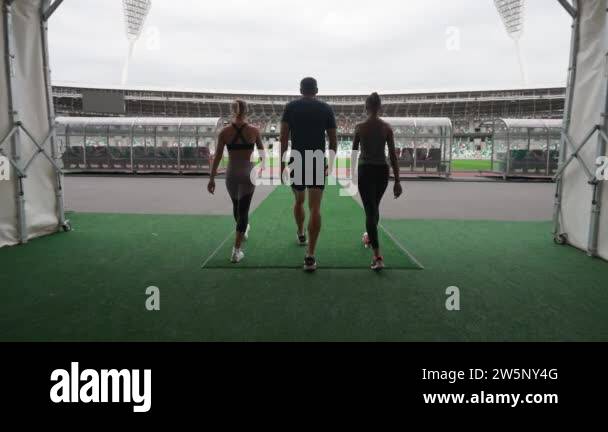 Professional athletes sprinters walk through the Olympic stadium, back ...