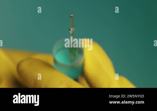 Syringe Needle with Liquid Dripping Drops of Medication in Doctor Hands ...