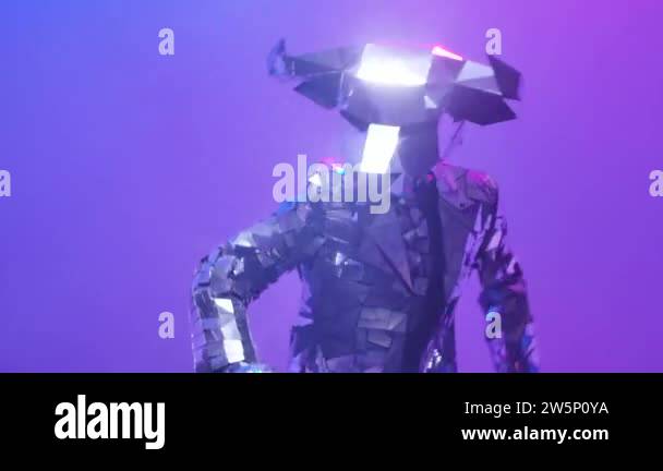Shiny bull in costume made of mirrors dancing robot dance on neon blue ...