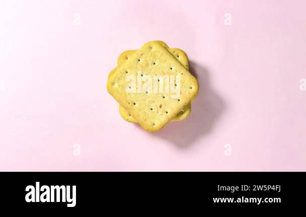 Stop motion animation. A square cracker that spins and flies in ...