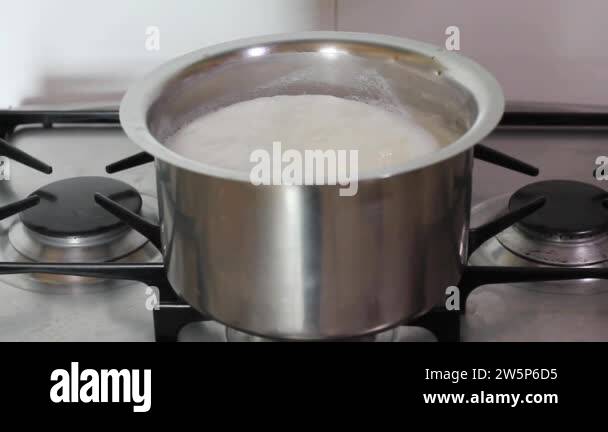 Milk boiling process shown in real time. Milk boiling in a saucepan ...