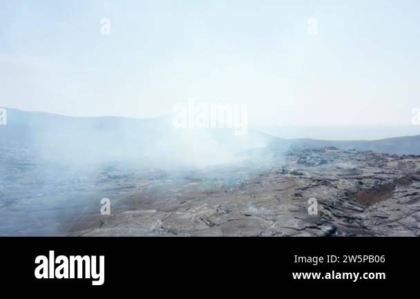 Low flight above new layer of lava after volcanic eruption. Revealing ...