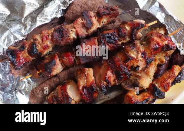 Grilled meat in disposable packaging and aluminum foil, delivered from ...