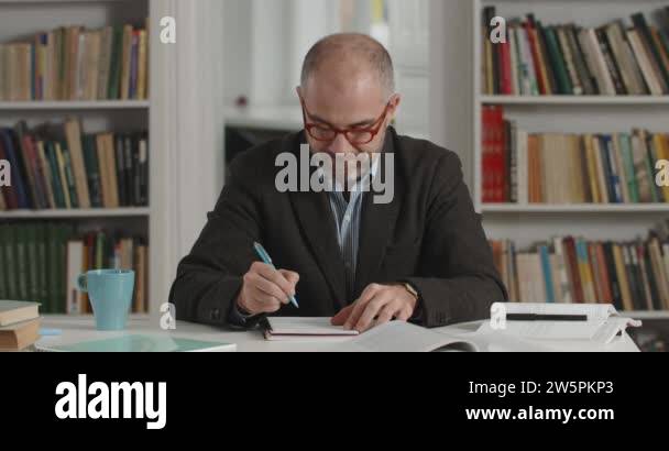 Crop view of positive man in suit raising head and looking to camera ...