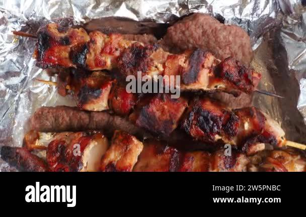 Grilled meat in disposable packaging and aluminum foil, delivered from ...